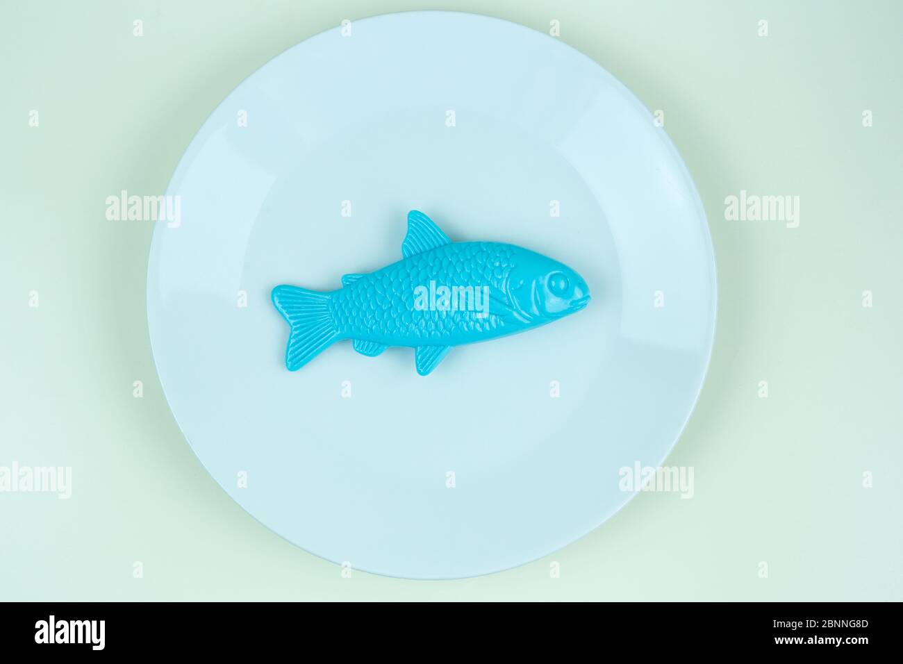 Blue plastic fish on white background Stock Photo - Alamy