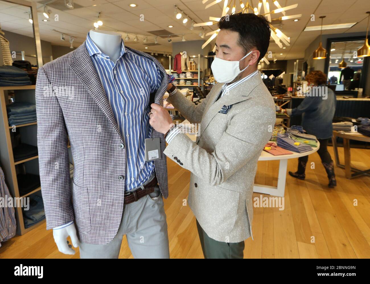 Ladue, United States. 15th May, 2020. Clerk Simon Rhim, dresses a ...