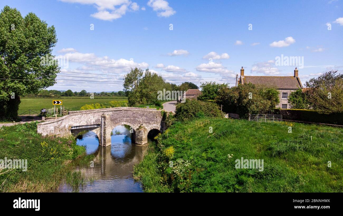 A pretty village cottage next to a countryside river in Somerset Stock ...