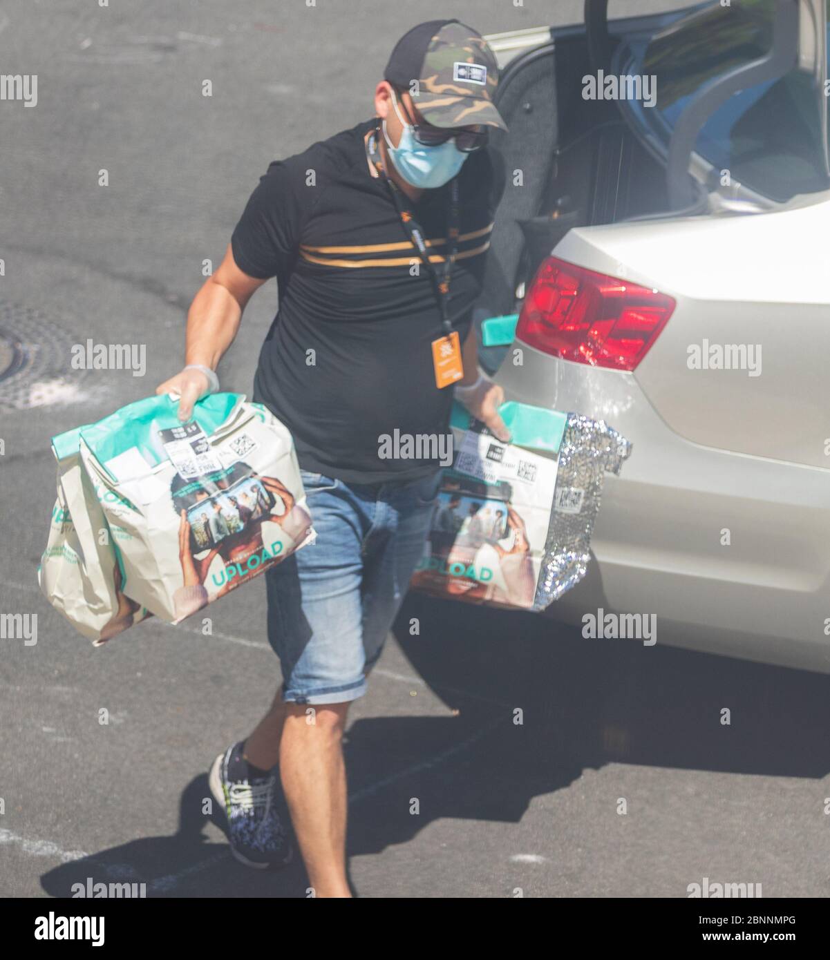 May 15, 2020: An Amazon Fresh delivery worker drops off groceries in ...
