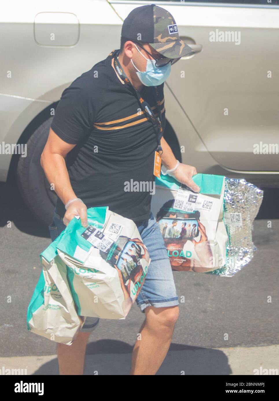 May 15, 2020: An Amazon Fresh delivery worker drops off groceries in ...
