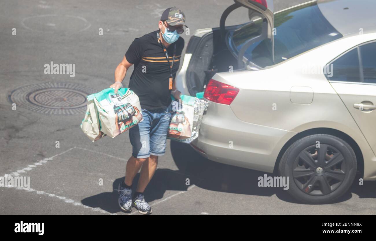 May 15, 2020: An Amazon Fresh delivery worker drops off groceries in ...