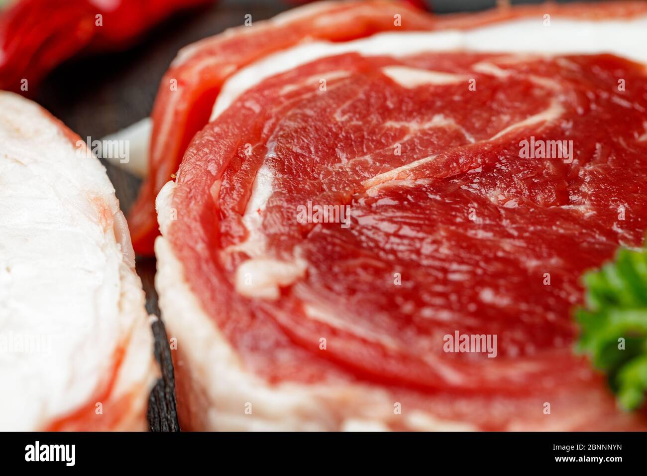 fresh meat with ingredients for cooking on dark background Stock Photo ...
