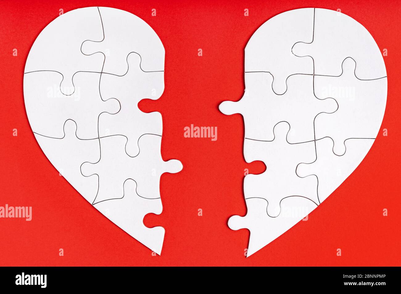 Two matching halves of one heart on red. Care, health, support, love ...