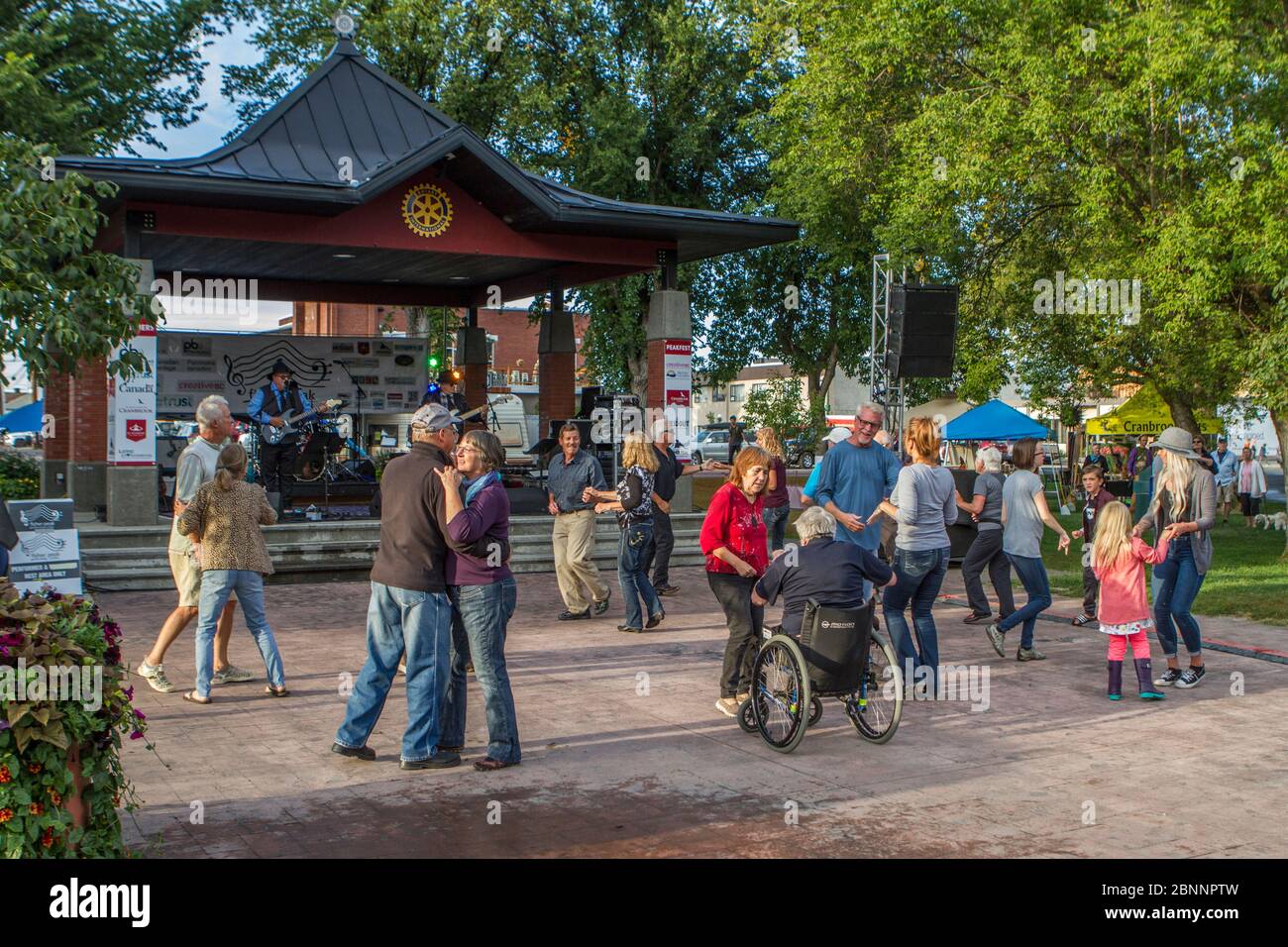 Band in outdoor concert with crowd dancing to music Stock Photo - Alamy