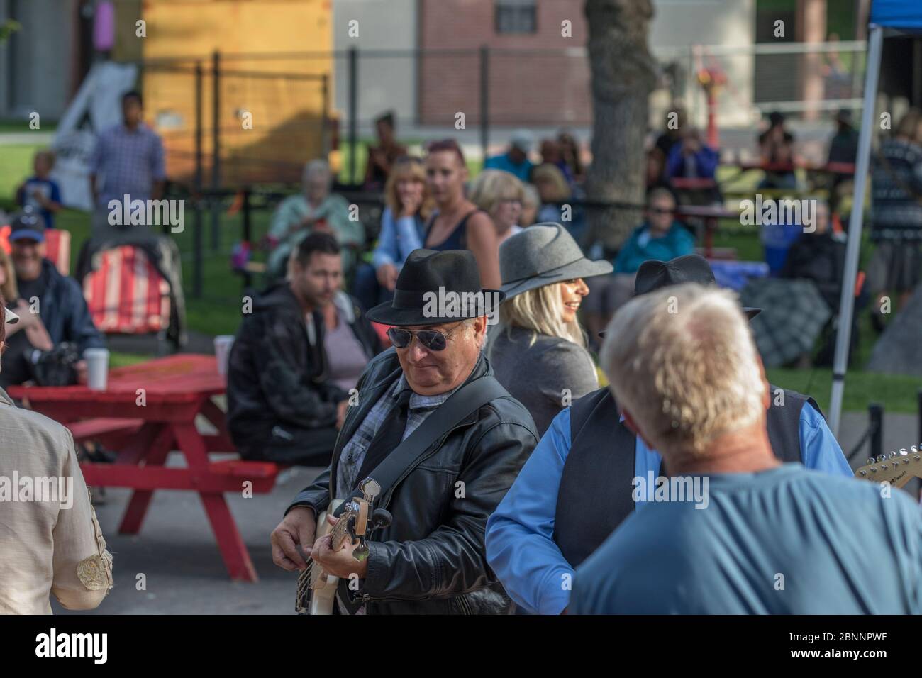 Male musicians playing at concert and mixing with crowd Stock Photo - Alamy
