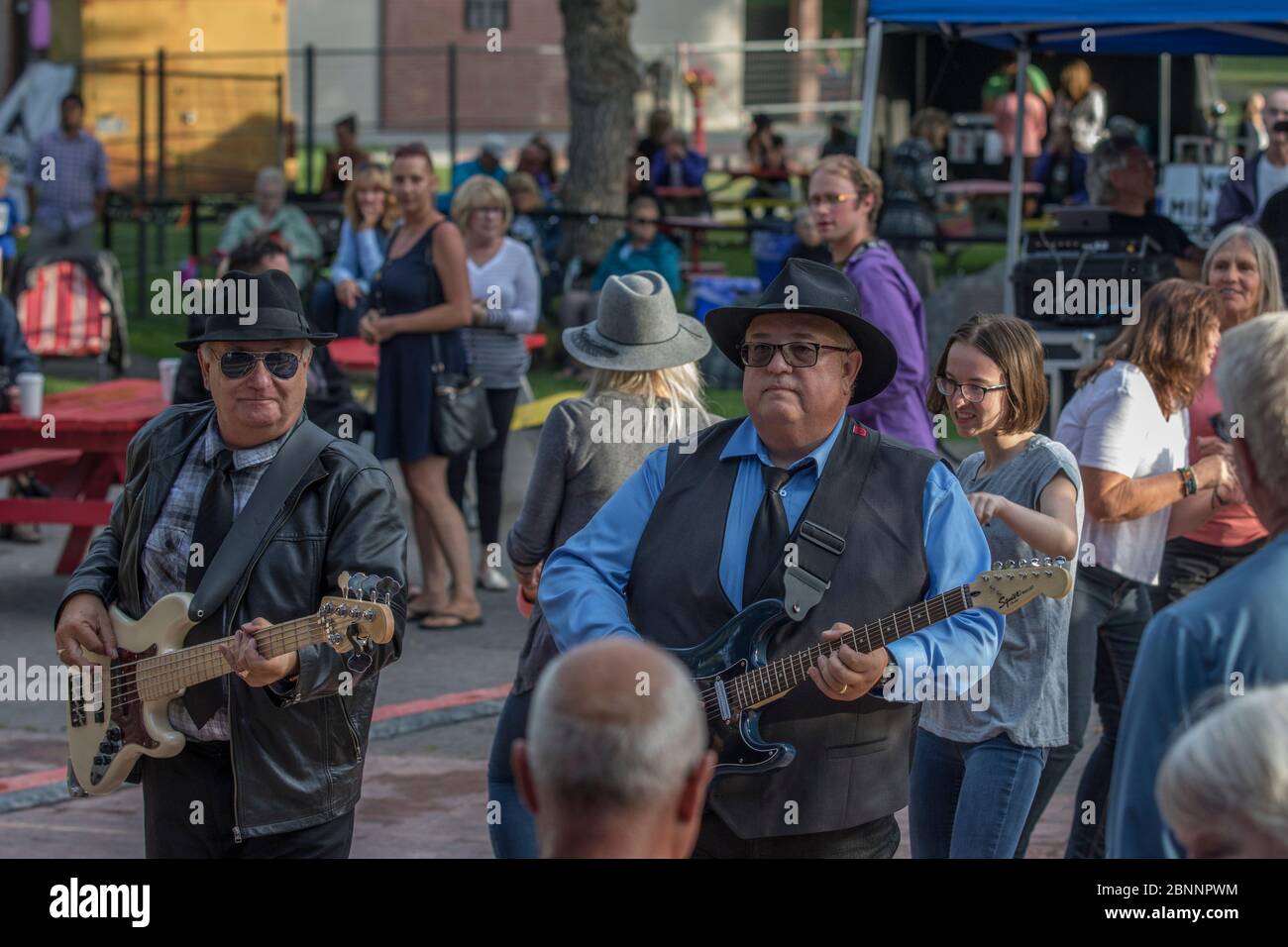 Male musicians playing at concert and mixing with crowd Stock Photo - Alamy