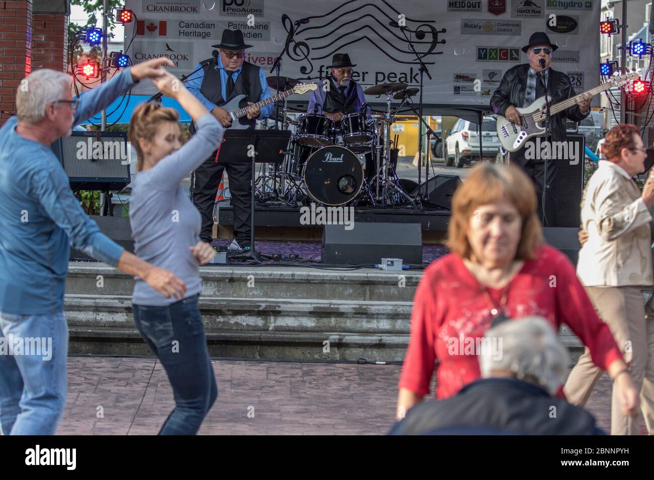 Band in outdoor concert with crowd dancing to music Stock Photo - Alamy