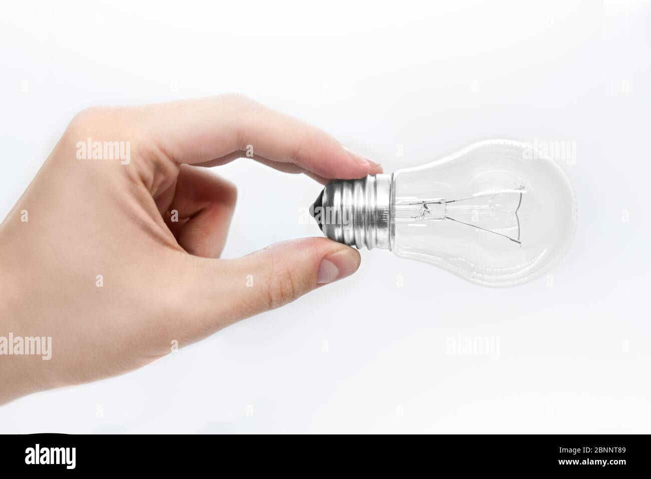 bulb in hand isolated on white background Stock Photo - Alamy