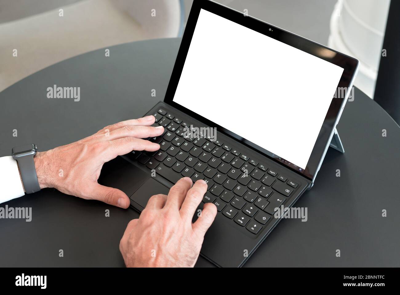 Hands on laptop keyboard with blank screen Stock Photo - Alamy