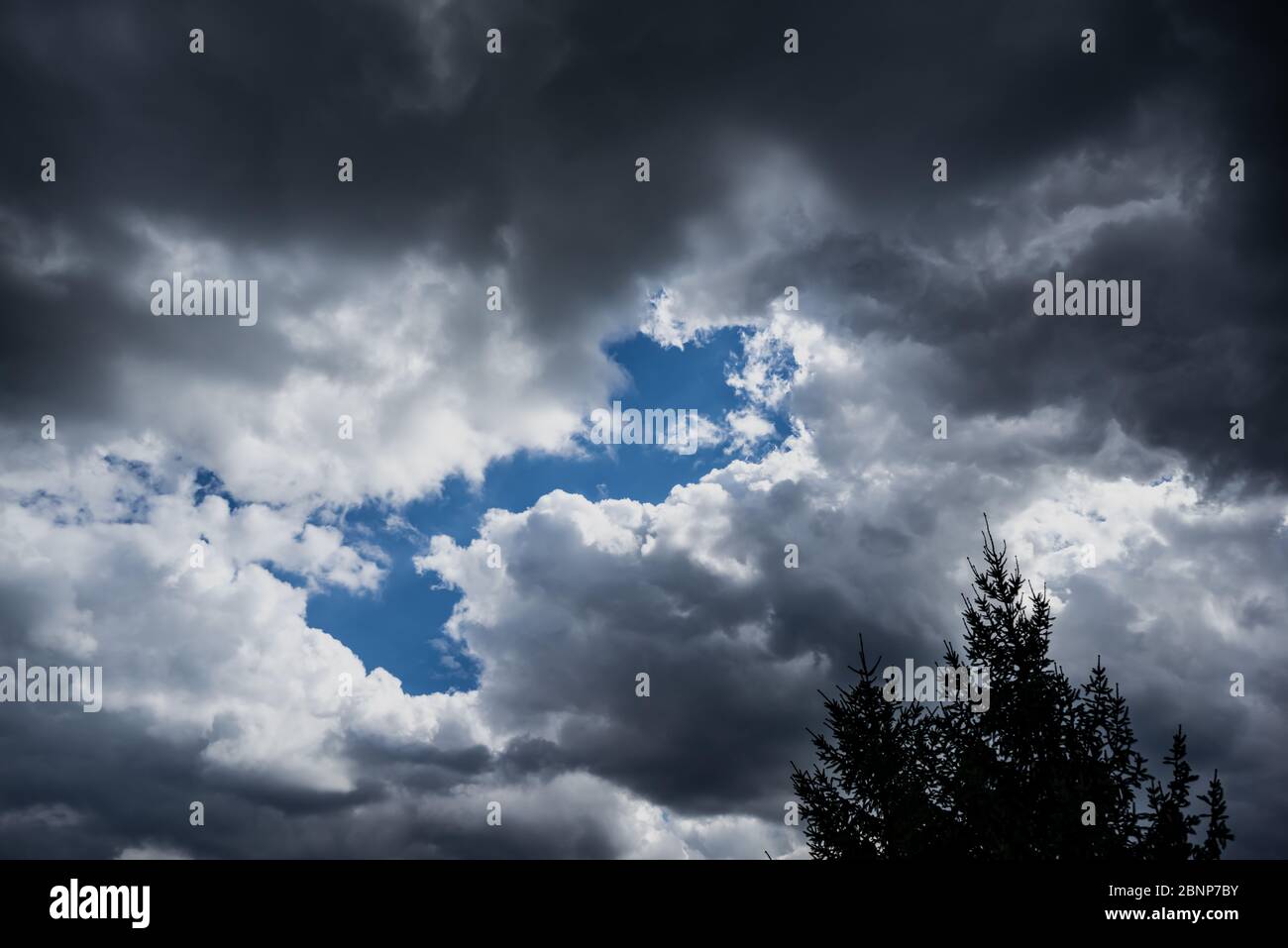 Rain clouds with a gap with blue sky hi-res stock photography and ...