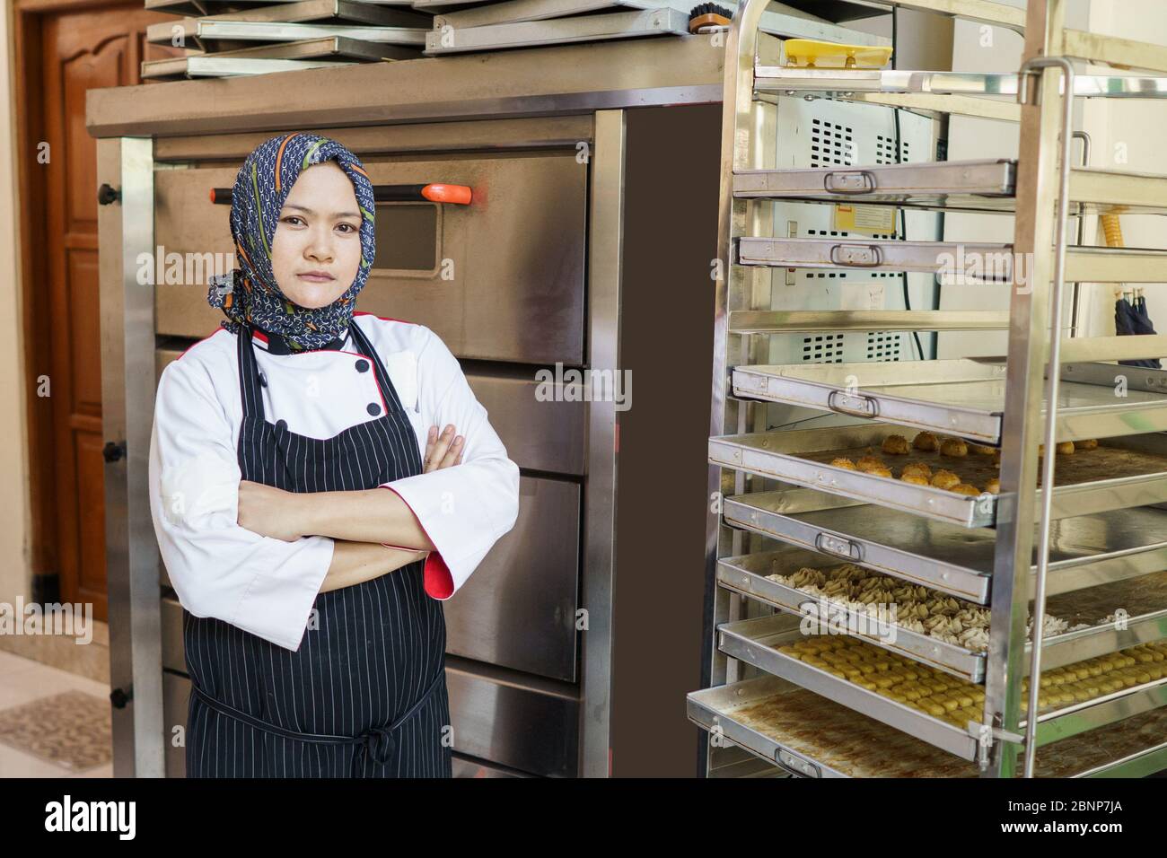 bakery shop owner female muslim chef standing proudly looking at camera ...