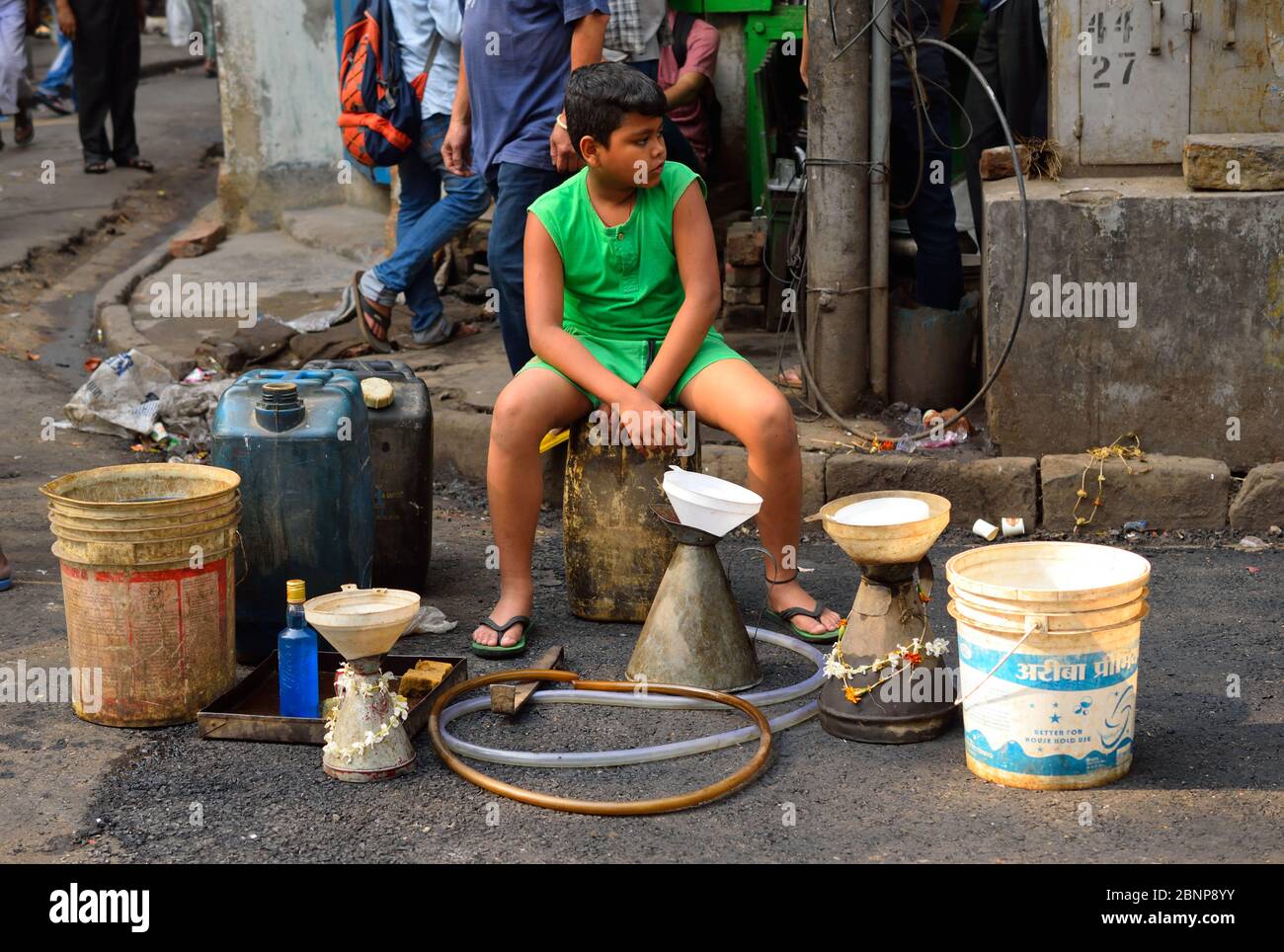 A boy selling kerosene oil in the market Stock Photo - Alamy