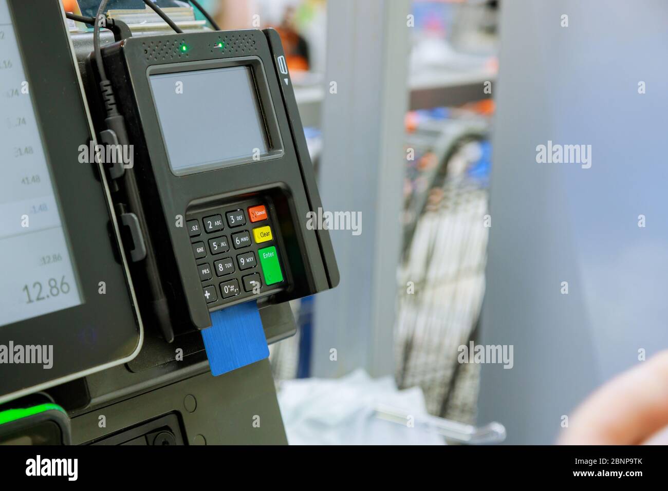 Closeup of moment of payment by credit card into a reader on store ...