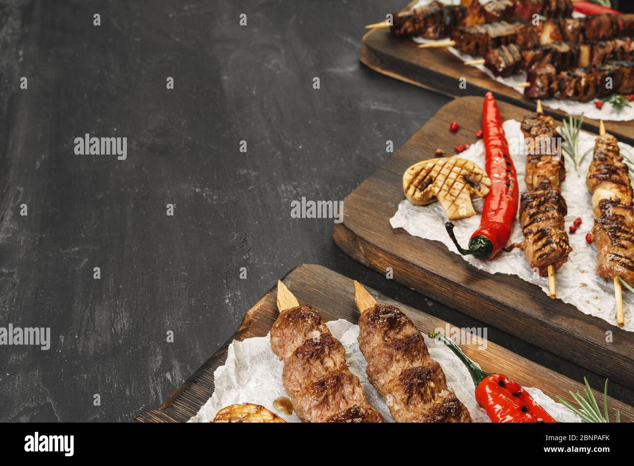 Grilled Lula kebab on skewers served on wooden board Stock Photo - Alamy