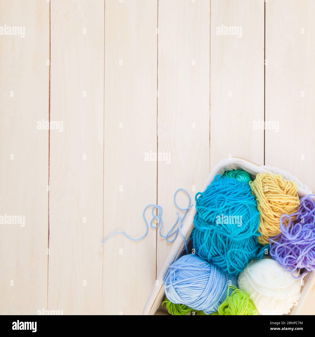 Color thread for knitting, knitted scarf, knitting needles on a dark ...