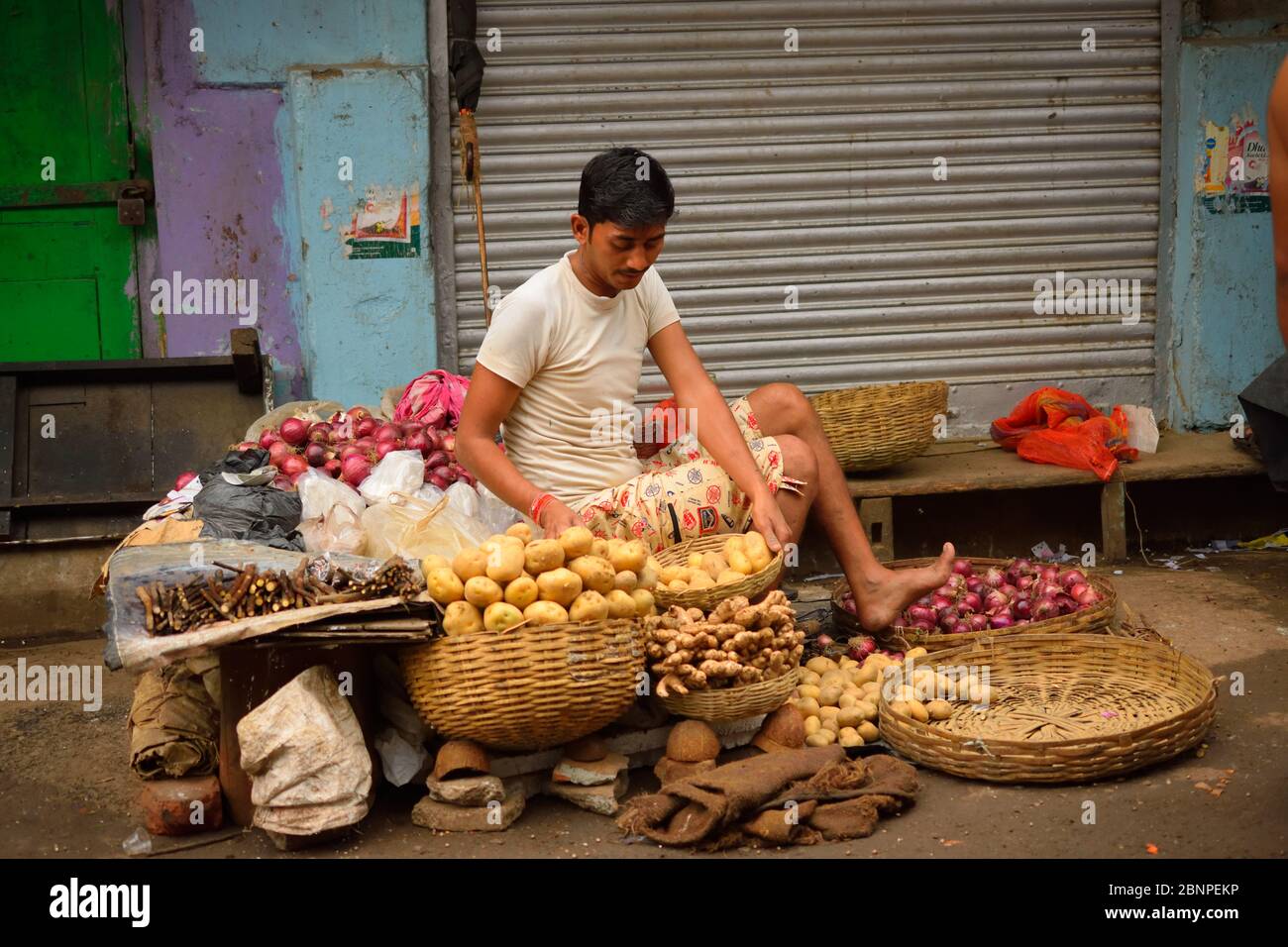 A street vendor selling vegetables in the market Stock Photo - Alamy