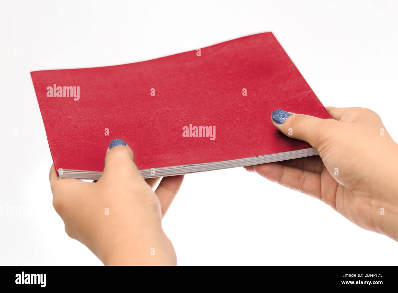 Two hands are holding up a book of paper on an isolated background. Add ...