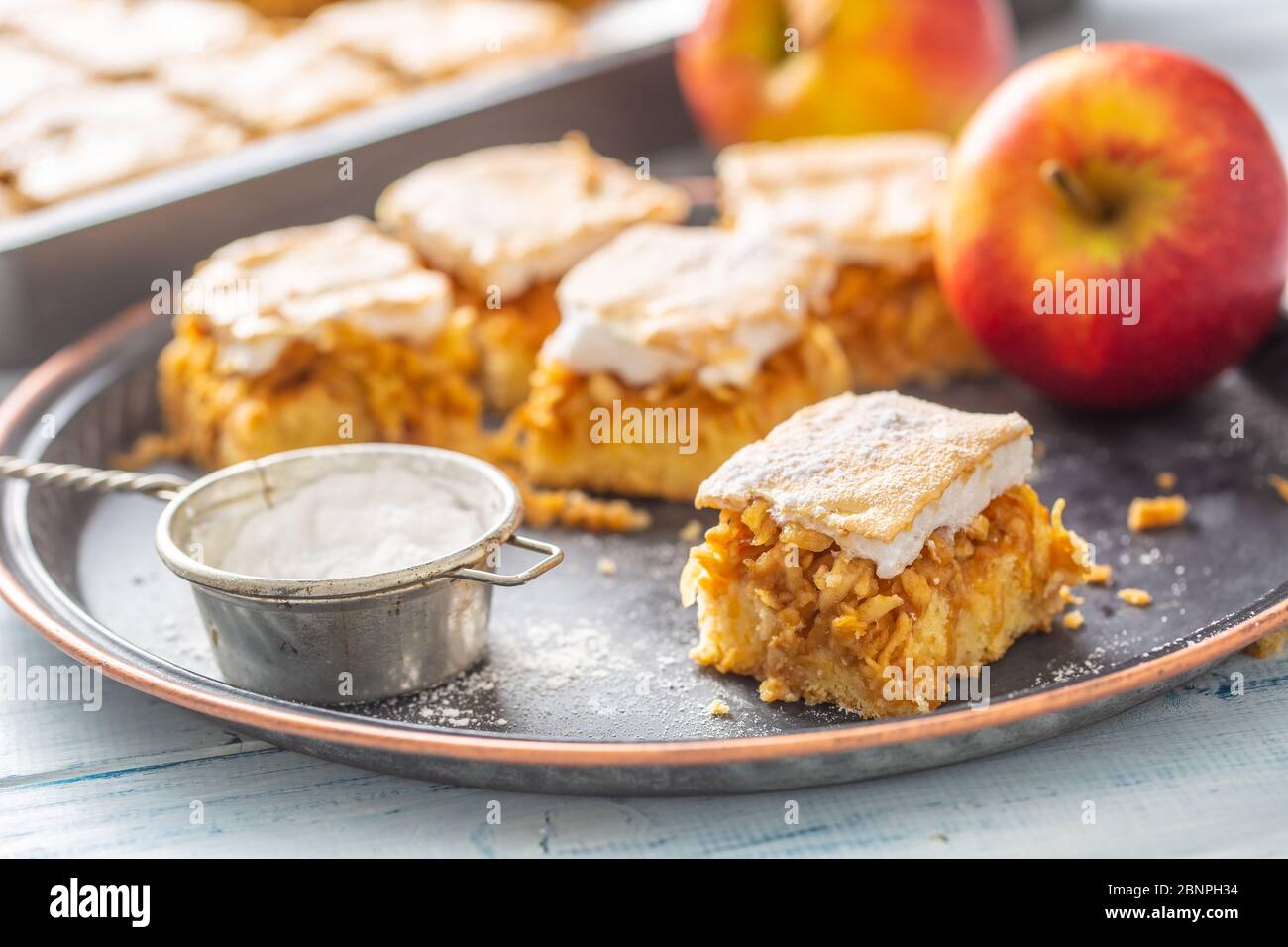 Applie pie cut to cubes with a fresh apple on a vintage tray with a ...
