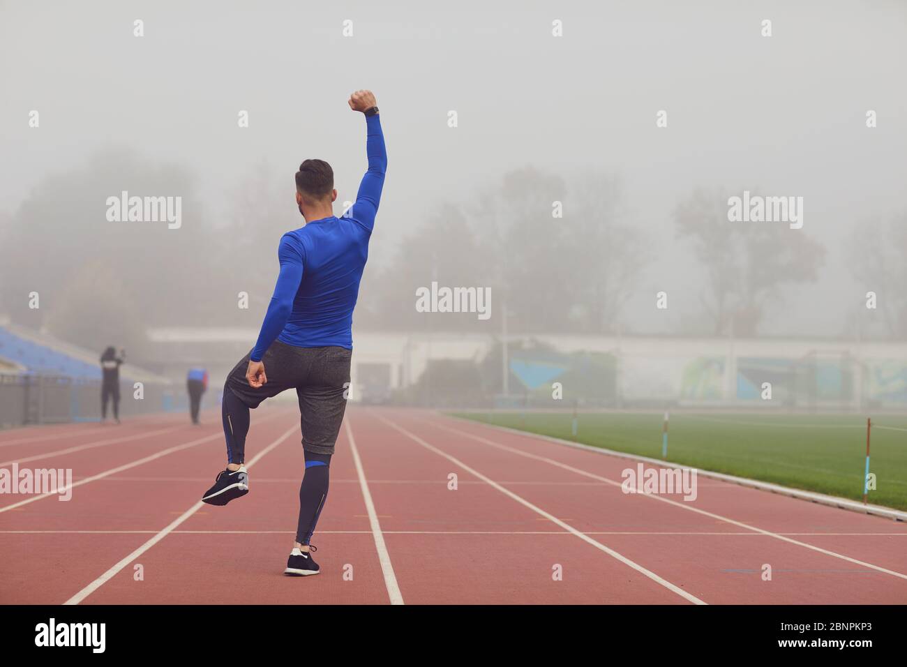 The guy the athlete raised his hands up at the stadium in the fog. The ...