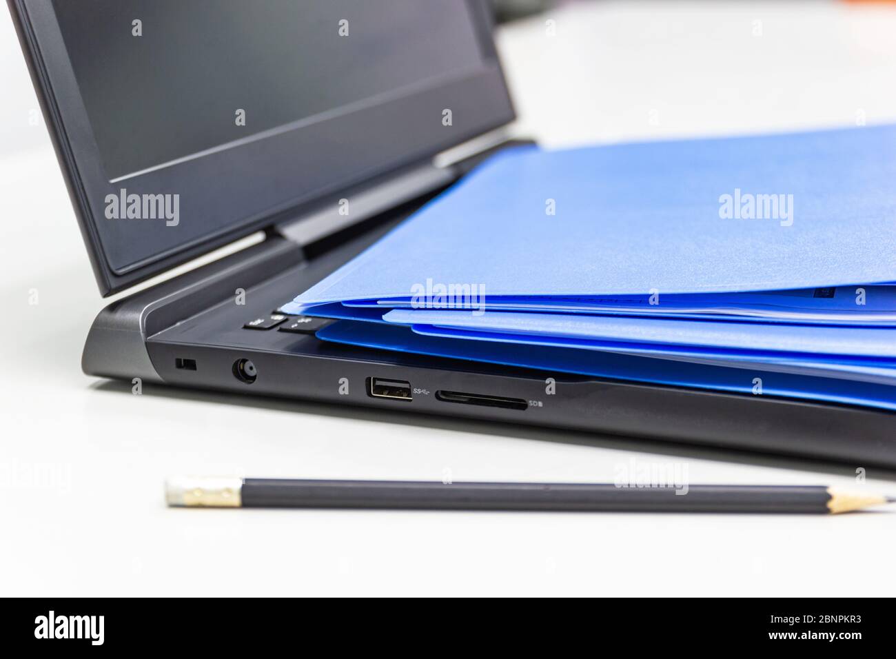 Close Up Blue file folder and Laptop Computer on desk in meeting room ...