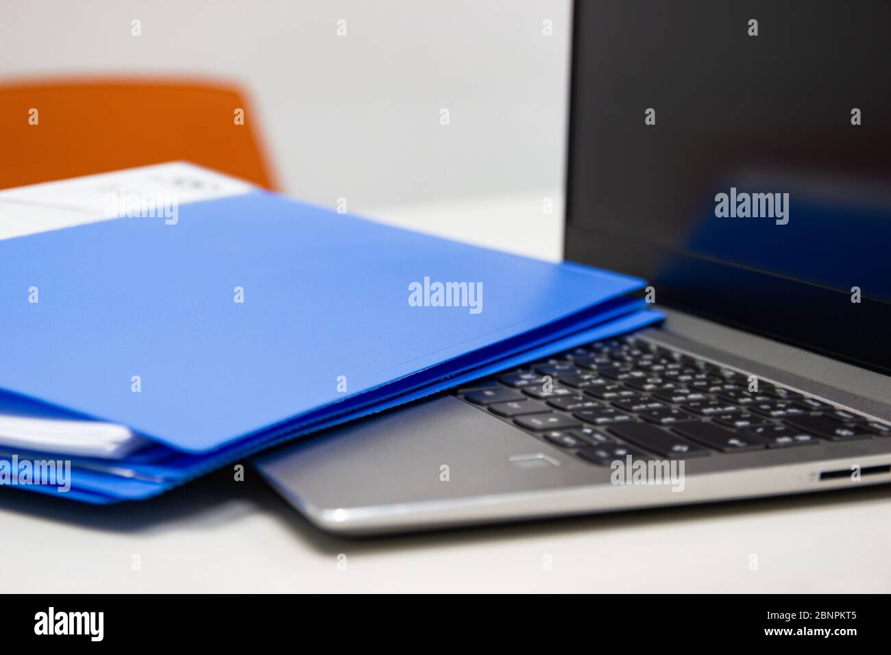 Close Up Blue file folder and Laptop Computer on desk in meeting room ...