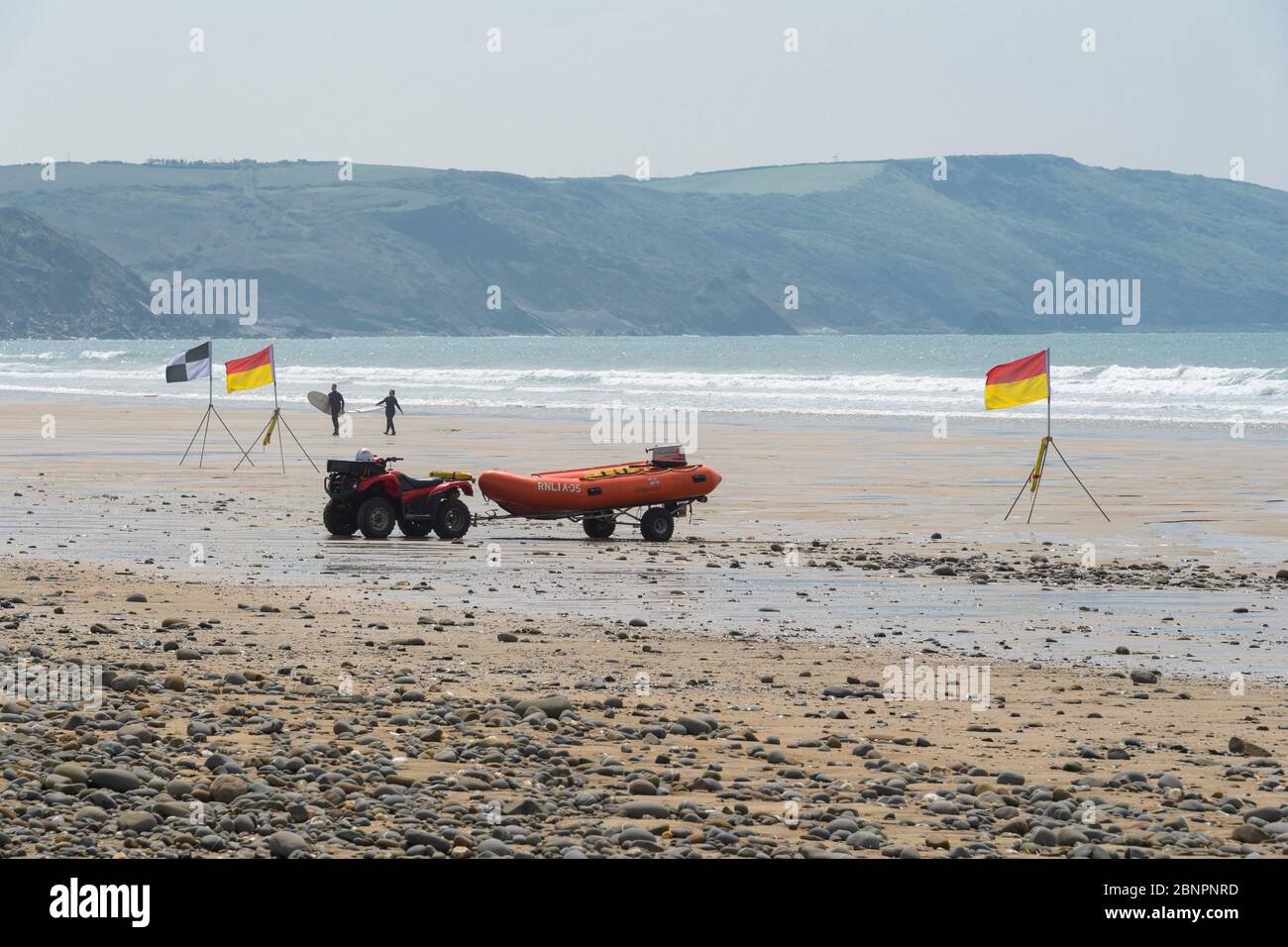 Surf beach with lifeguard flags in summer, Cornwall, South West England ...