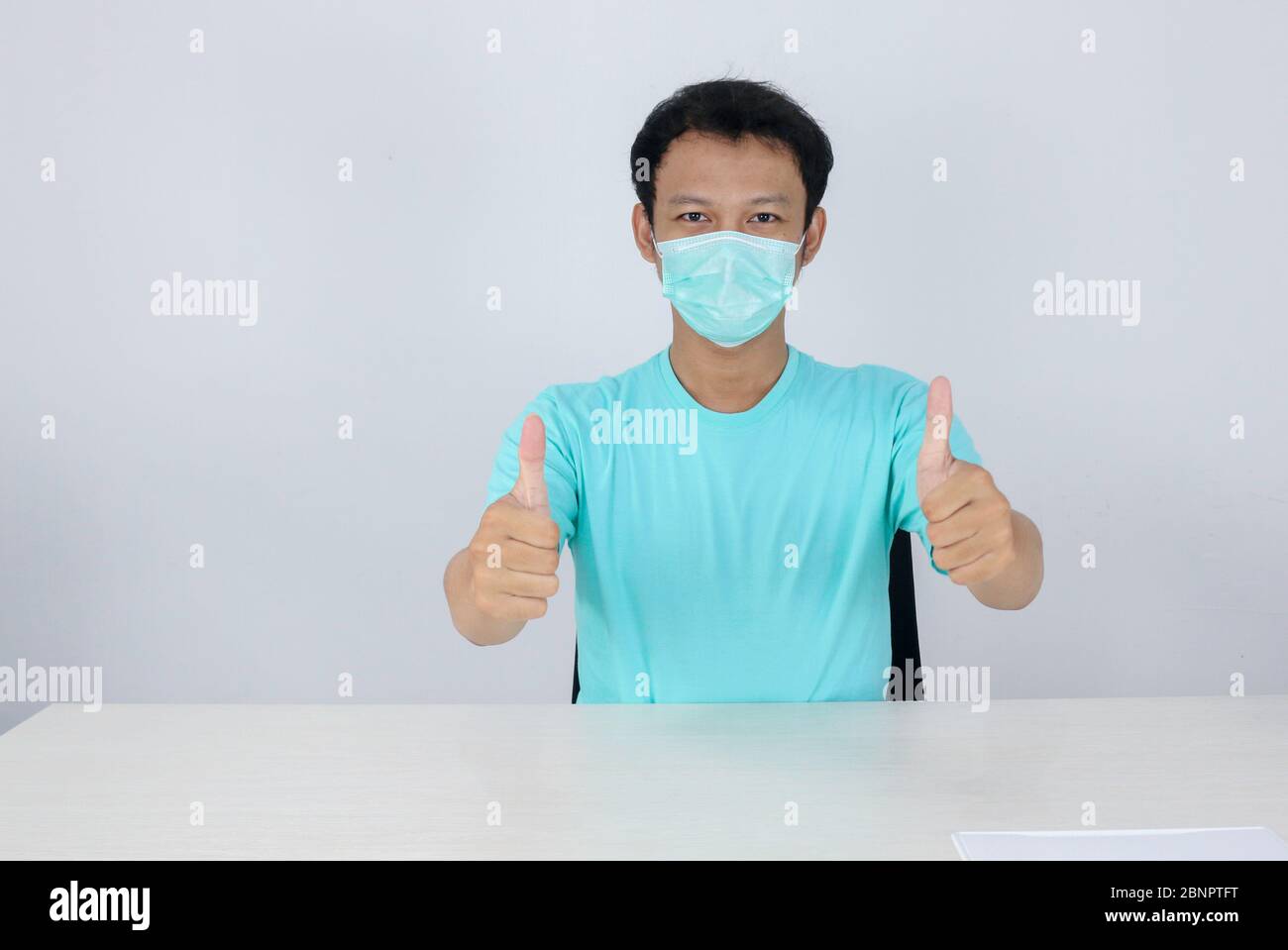 Young Asian Man wear medical mask is give ok hand sign with confident ...