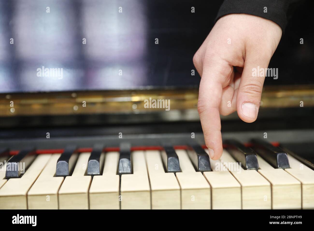 Finger touching the Piano key Stock Photo - Alamy