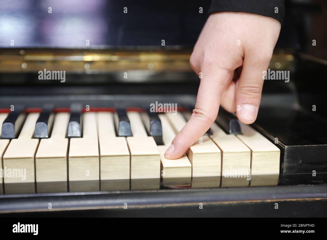 Finger touching the Piano key Stock Photo - Alamy