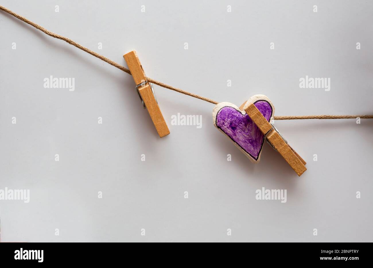 Love heart hanging on rope Stock Photo - Alamy