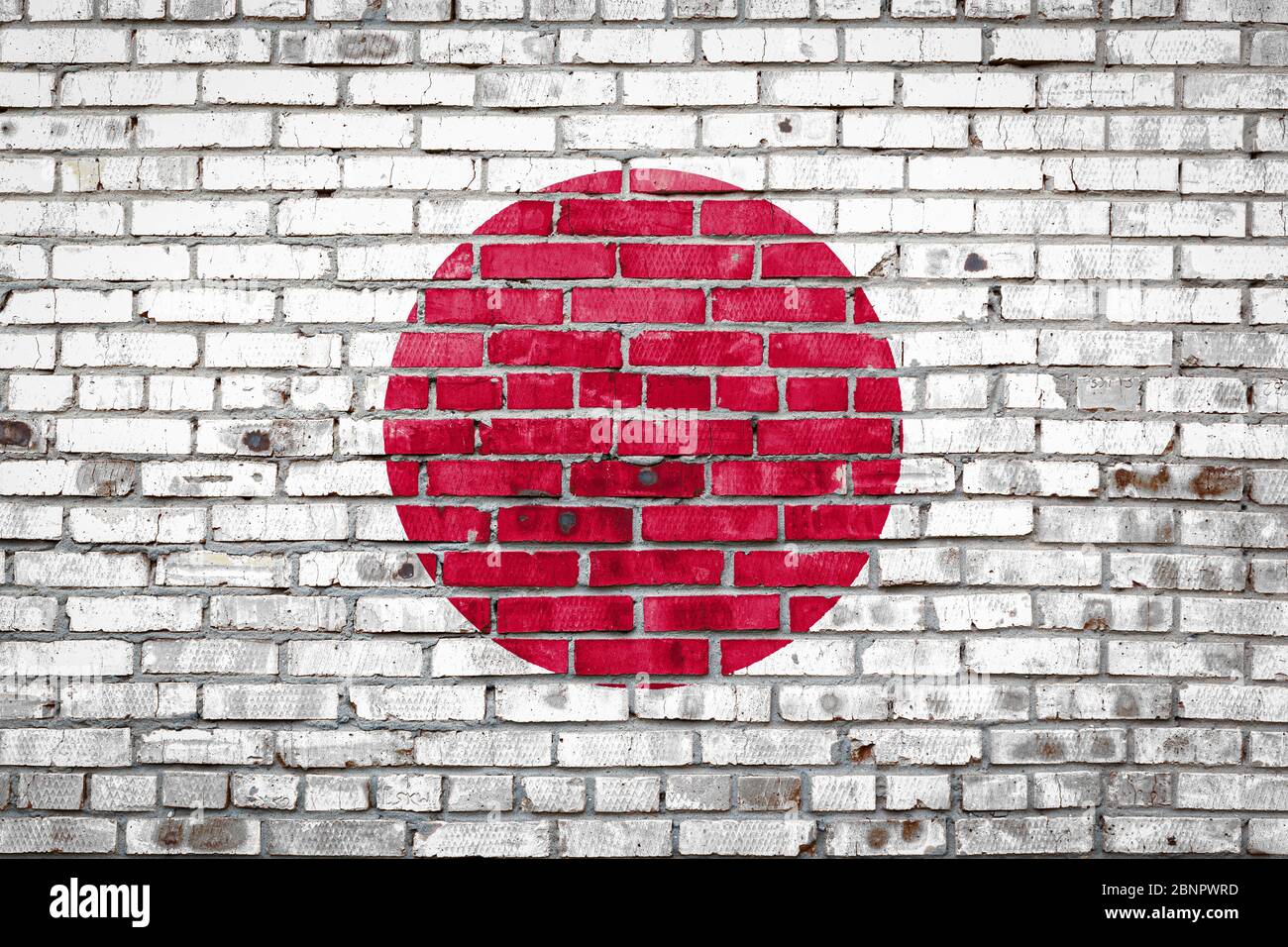 National flag of Japan depicting in paint colors on an old brick wall ...