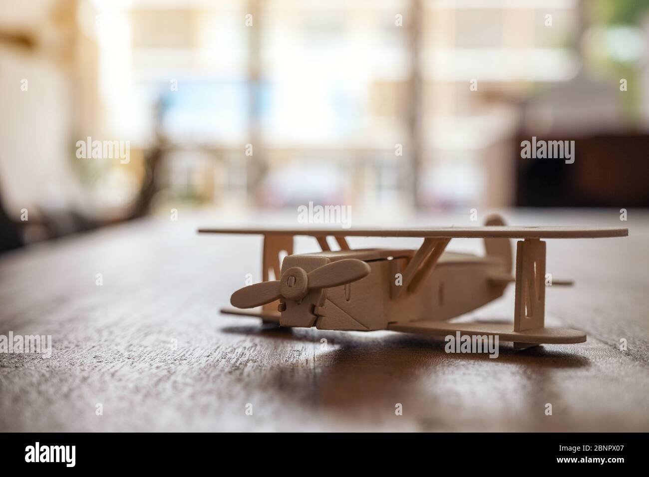 Closeup image of a wooden airplane on the table Stock Photo - Alamy