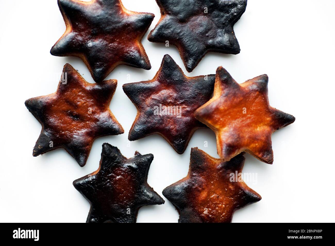 Burnt and overcooked star shaped pastries on a white background Stock ...