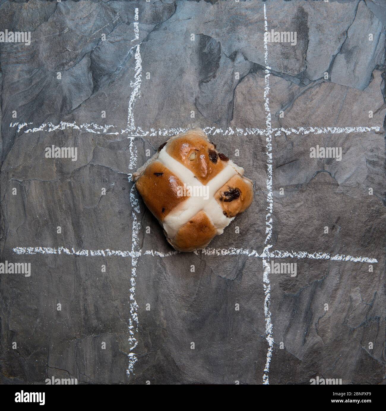 Playing noughts and crosses with donuts and hot cross buns, one of ...