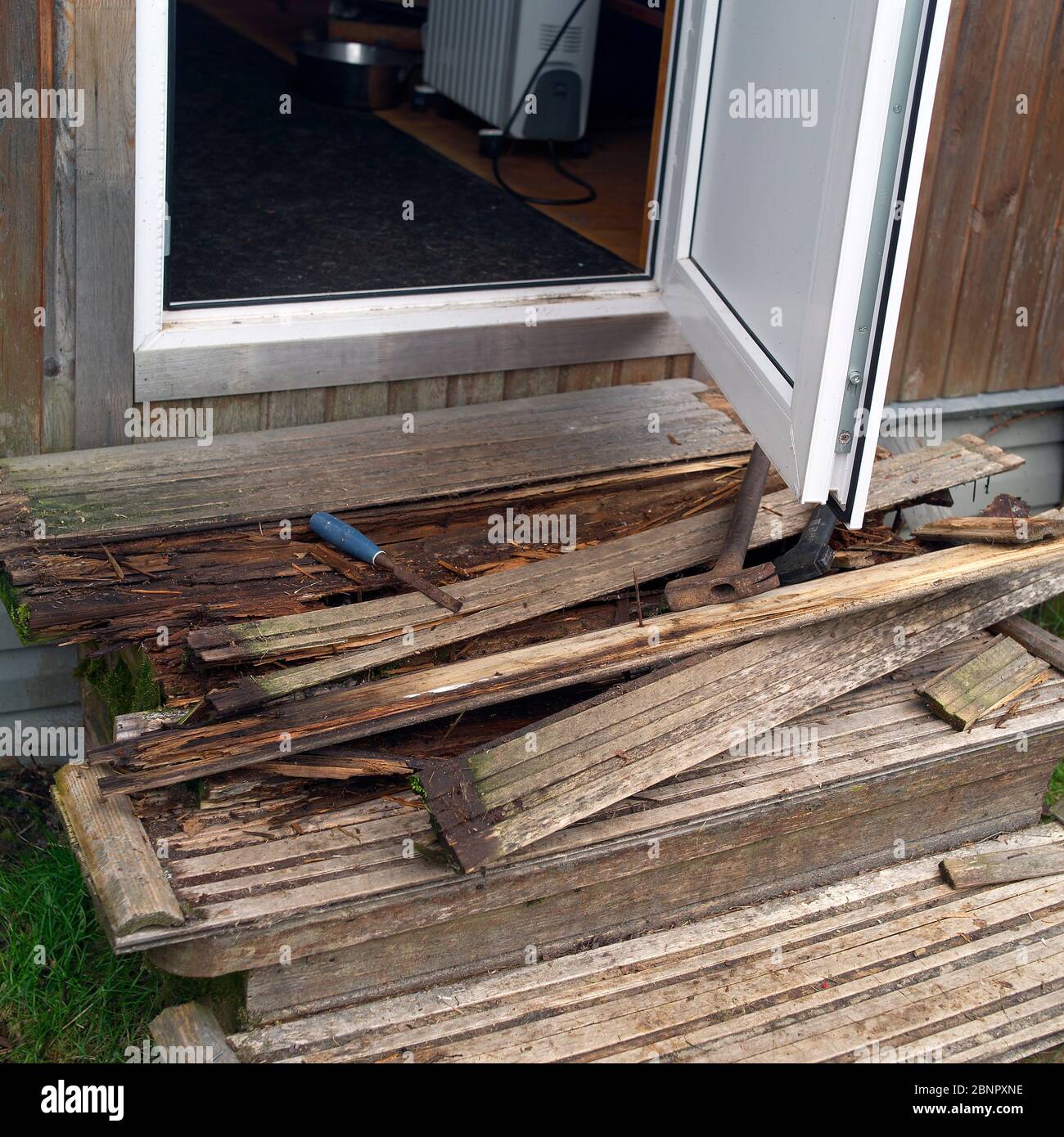 Rotten decking boards of a porch and open entrance door Stock Photo - Alamy