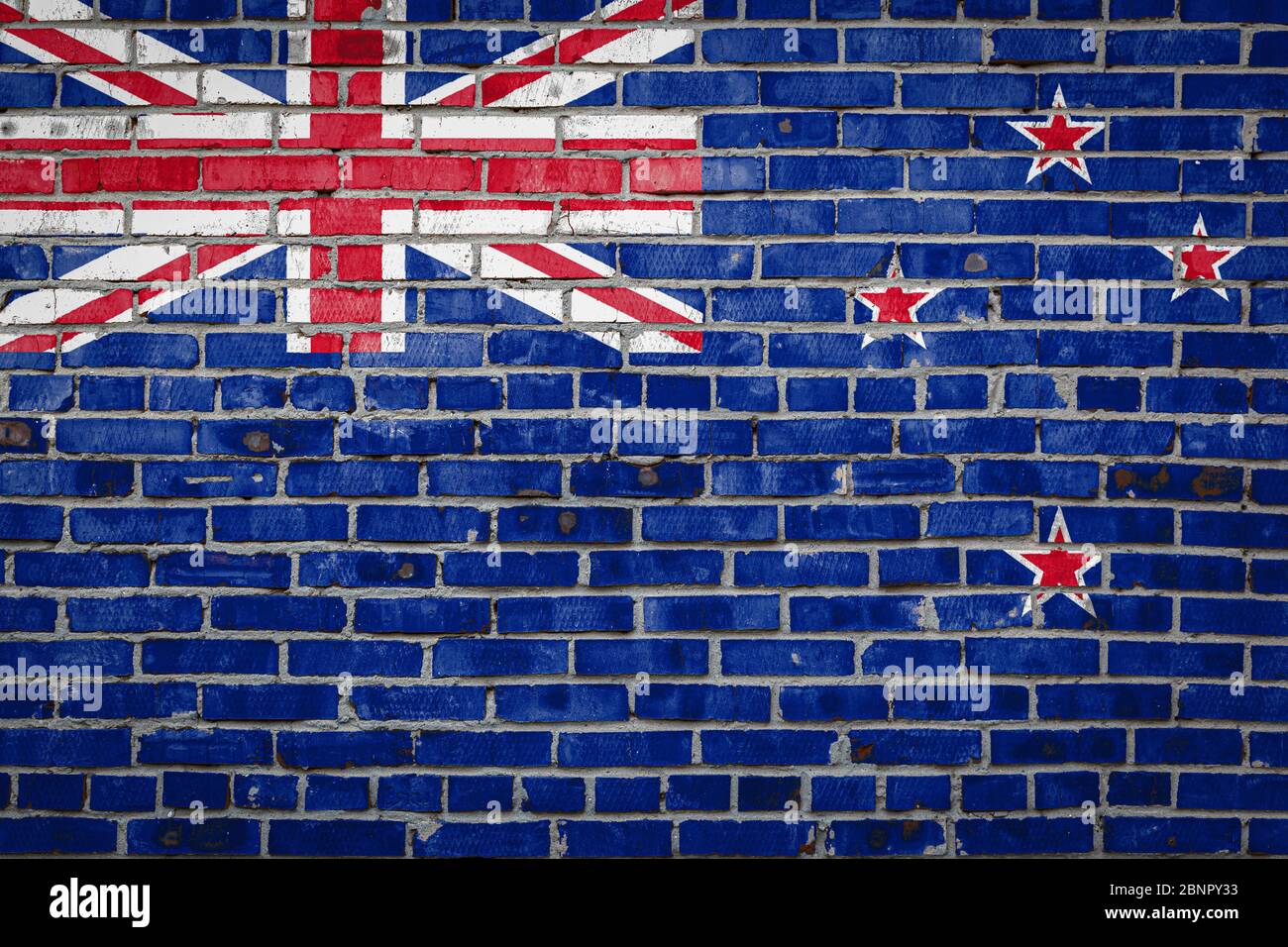 National flag of New Zealand depicting in paint colors on an old brick ...