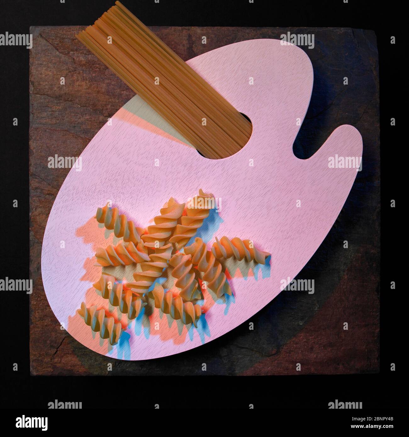 Wooden palette with dried pasta selection against slate background ...