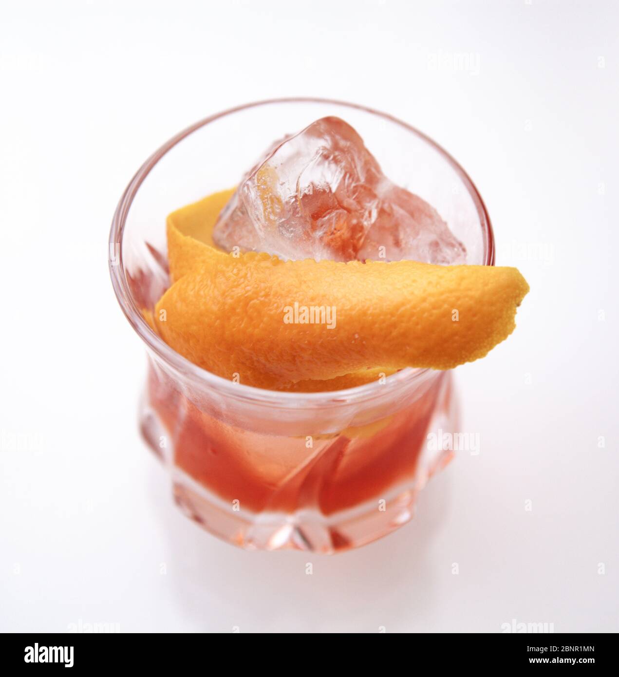 Reddish brown cocktail in a rocks glass on an isolated white background ...
