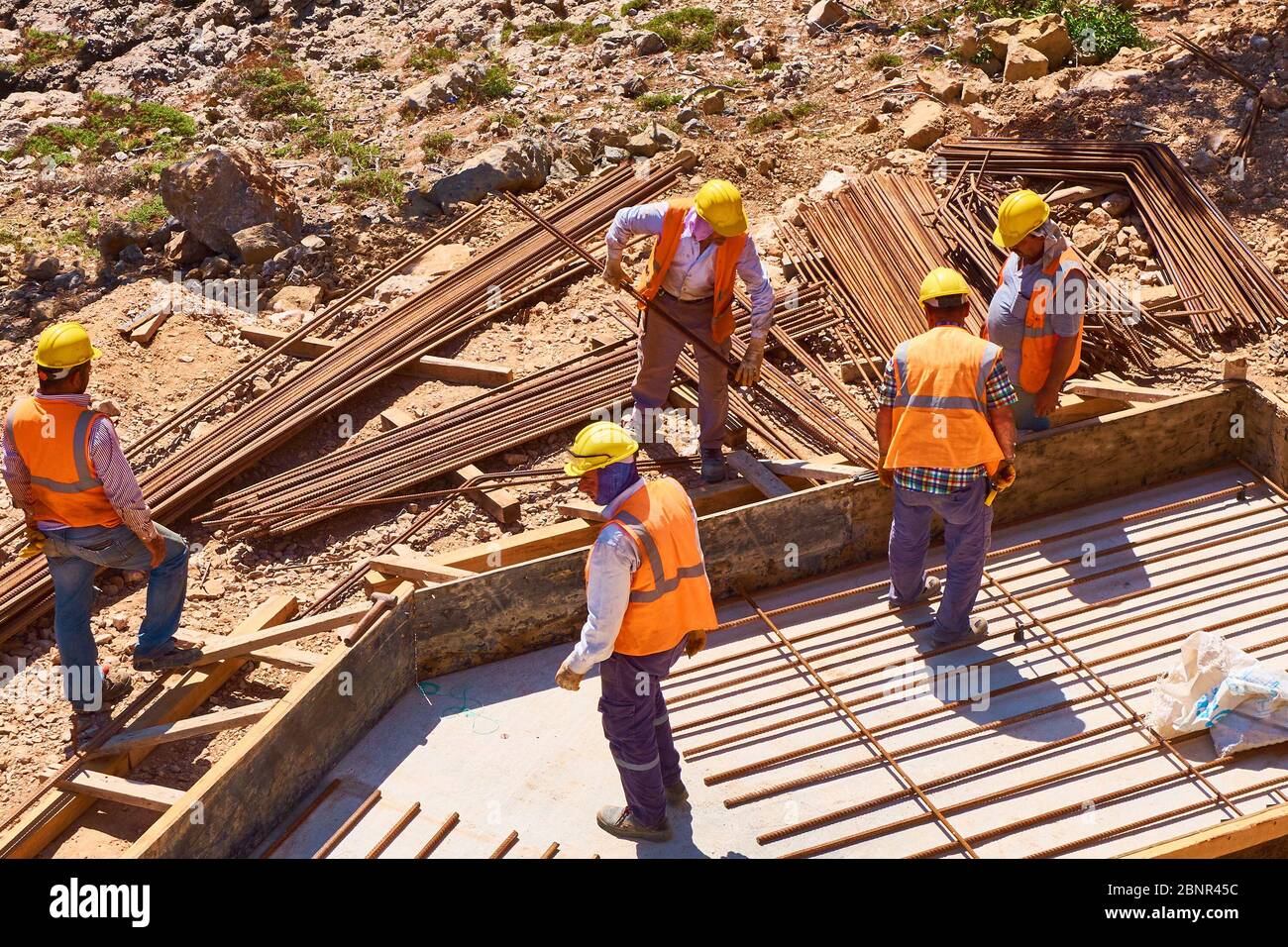 Workers are building concrete reinforced foundation plate at ...