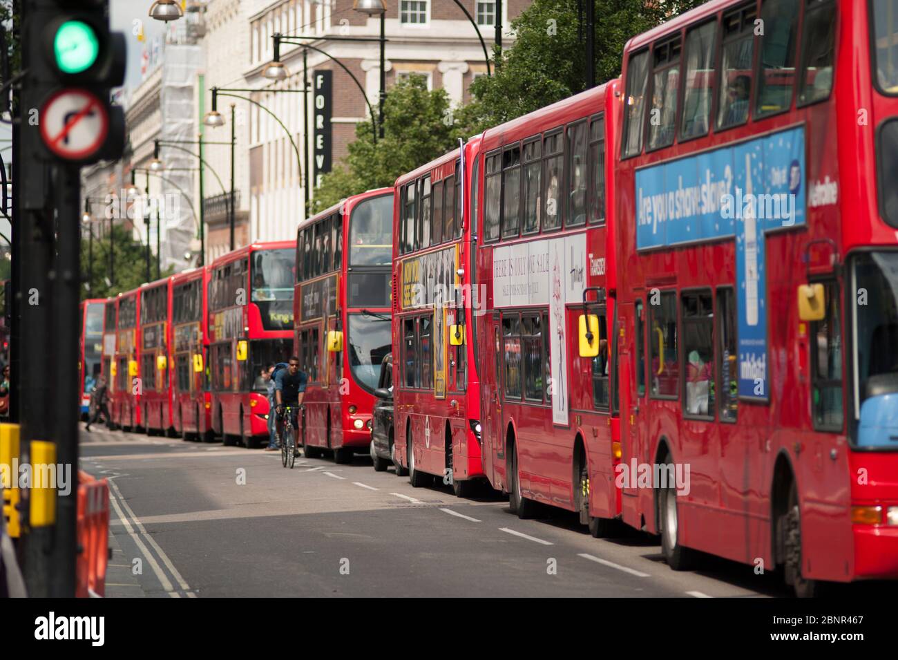 Public transport congestion in London’s Oxford Street with a cyclist ...