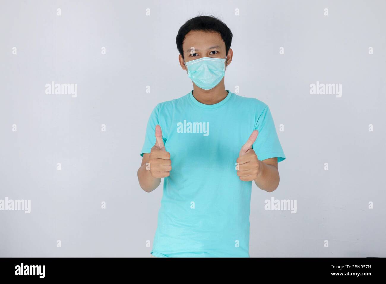 Young Asian Man wear medical mask is give ok hand sign with confident ...