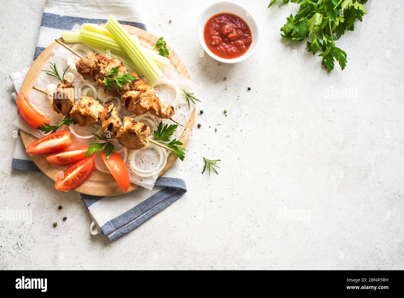 Grilled pork kebabs on skewers on white background, top view, copy ...