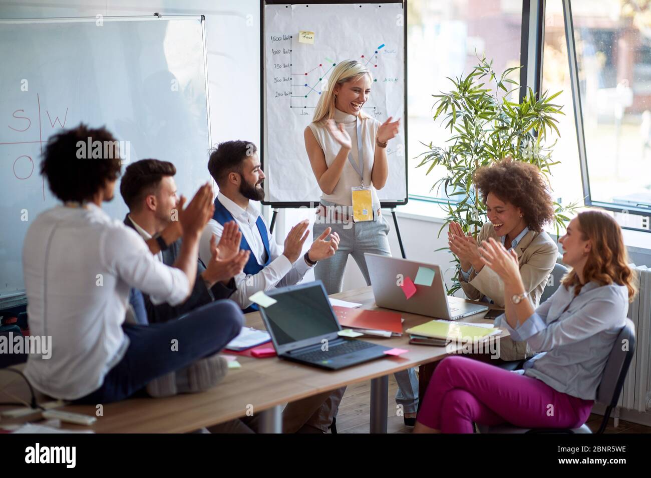 Coworkers applauding a colleague. Applause at a business meeting ...