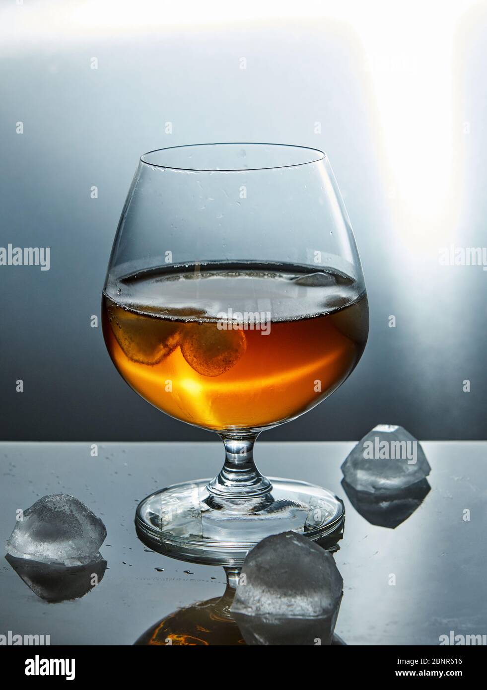 A glass of whiskey with ice. Conceptual design Stock Photo - Alamy
