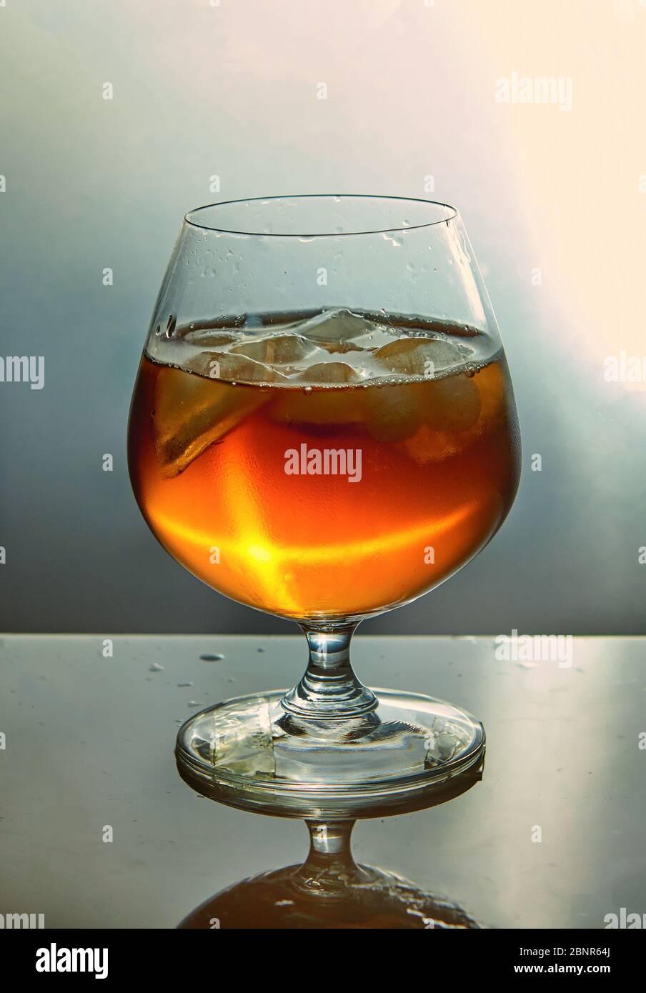 A glass of whiskey with ice. Conceptual design Stock Photo - Alamy