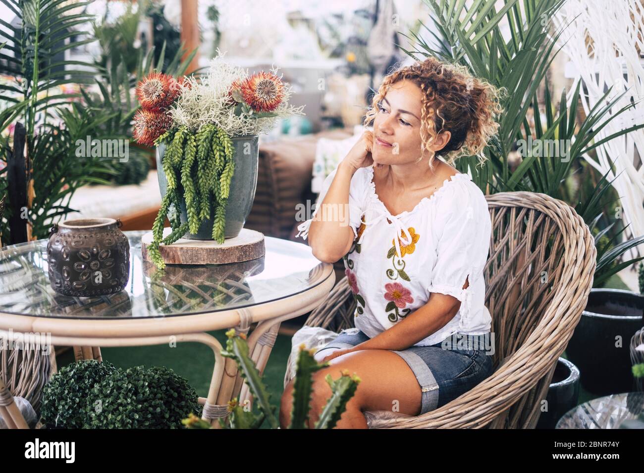 Caucasian happy relaxed woman. enjoying the garden ay home - plants and ...
