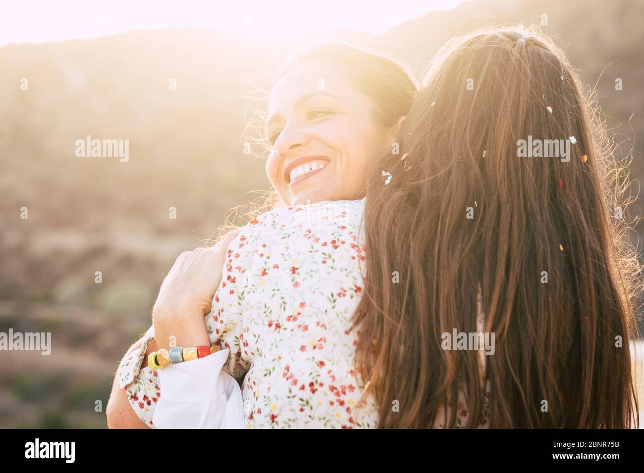 Love and friendship diversity concept - couple of females hug with love ...