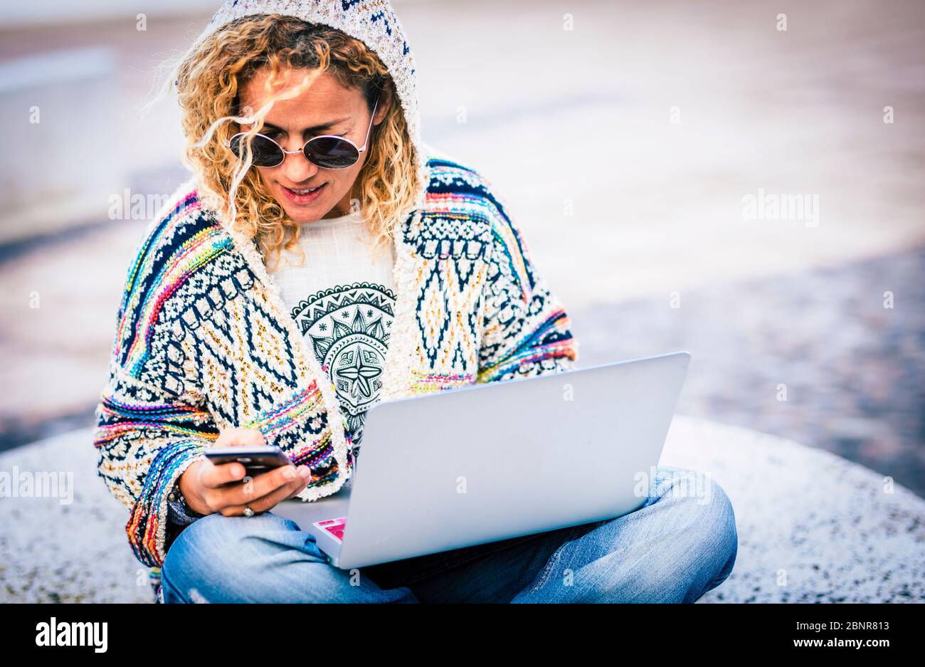 Woman at work with roaming internet technology outdoor during travel ...