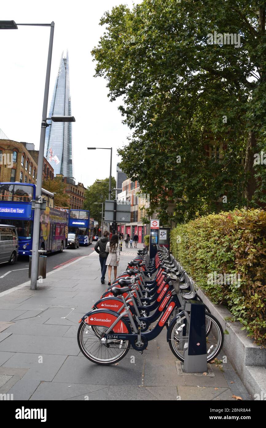 Lines of Santander bikes in a rack on the pavement in London with the ...